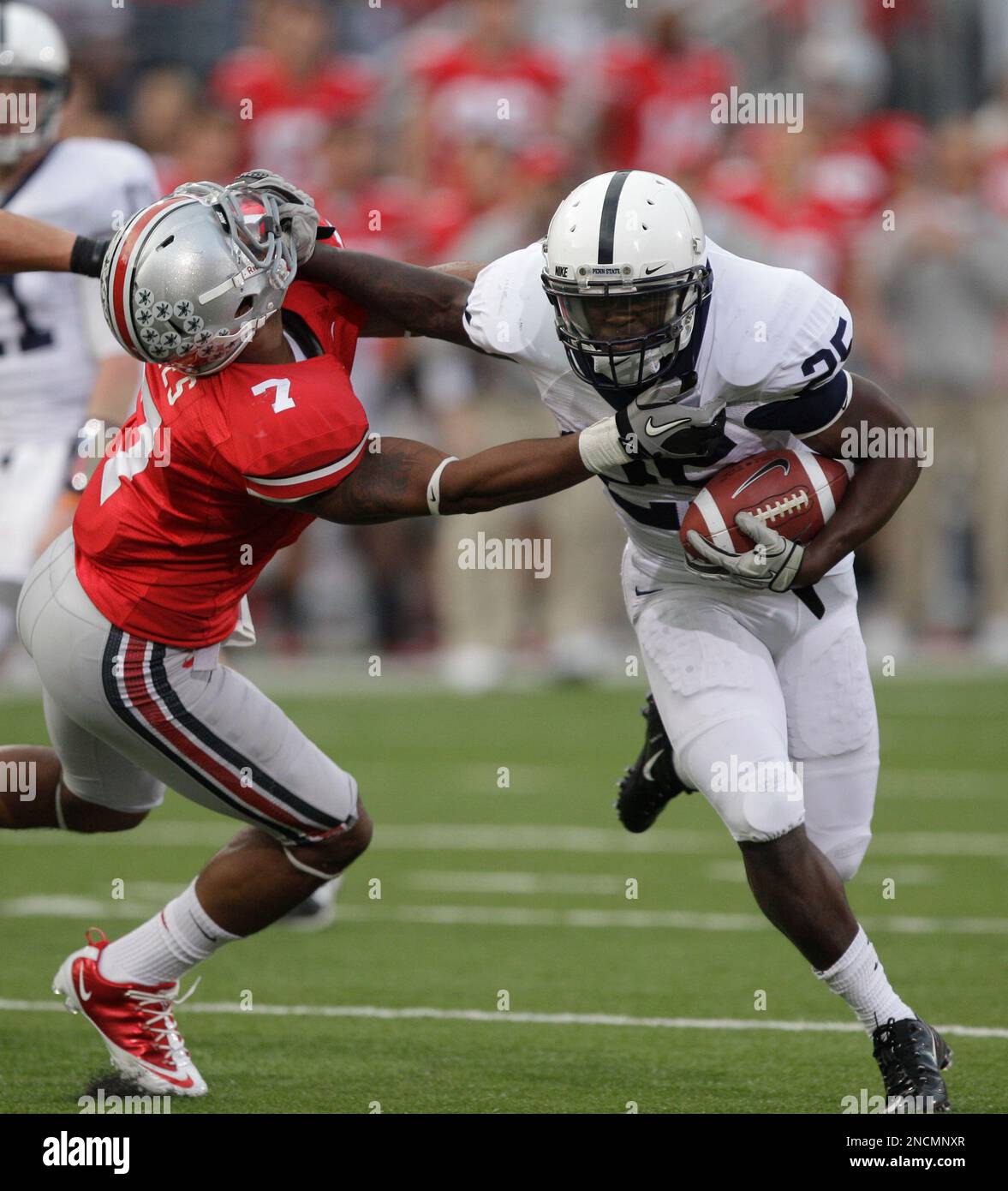 Penn State running back Silas Redd (25) pushes off Ohio State defender ...