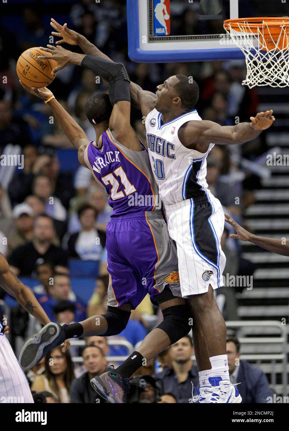 Orlando Magic's Brandon Bass, right, tries to block a shot by Phoenix ...