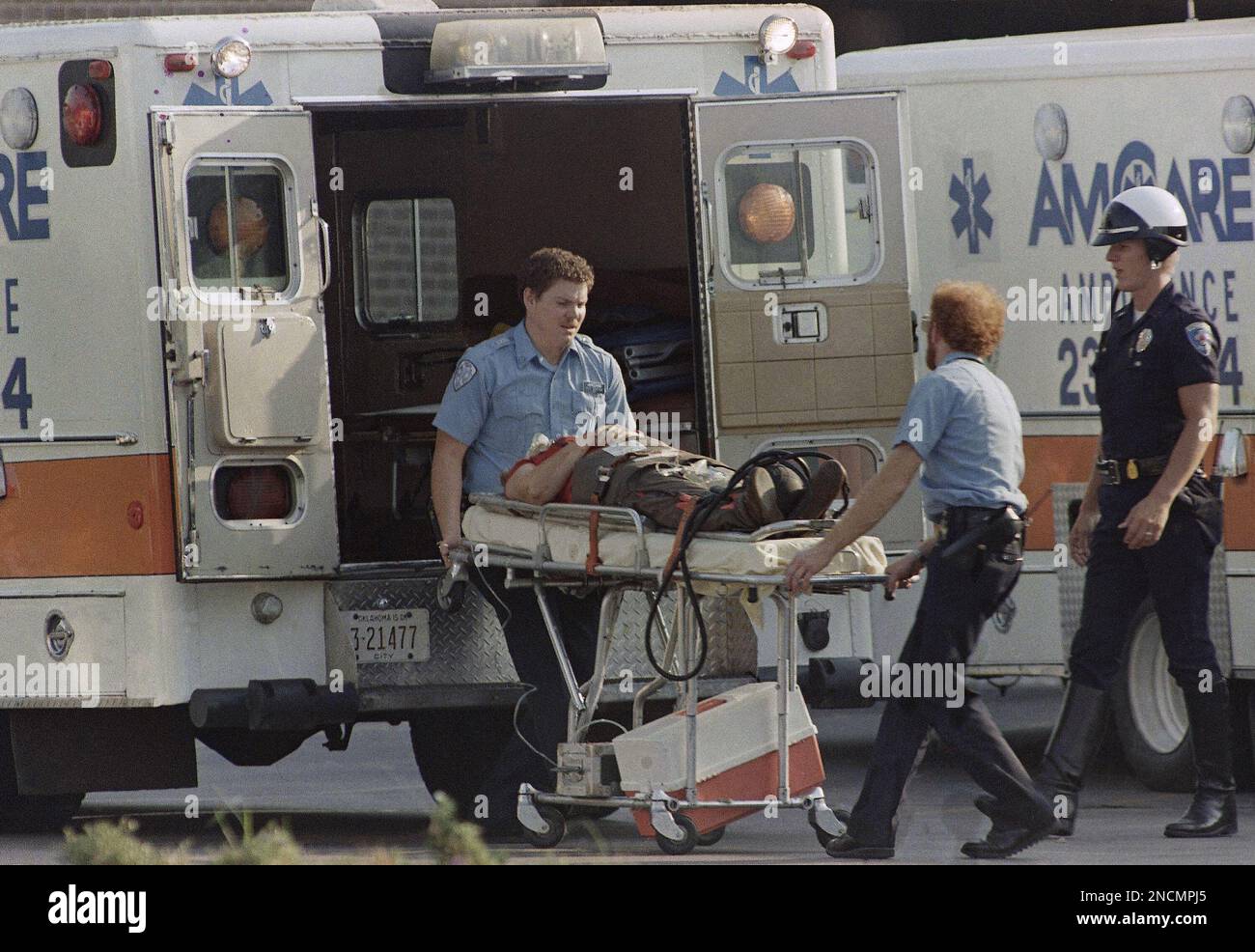 Medical personal rush a wounded man to a waiting ambulance following a ...