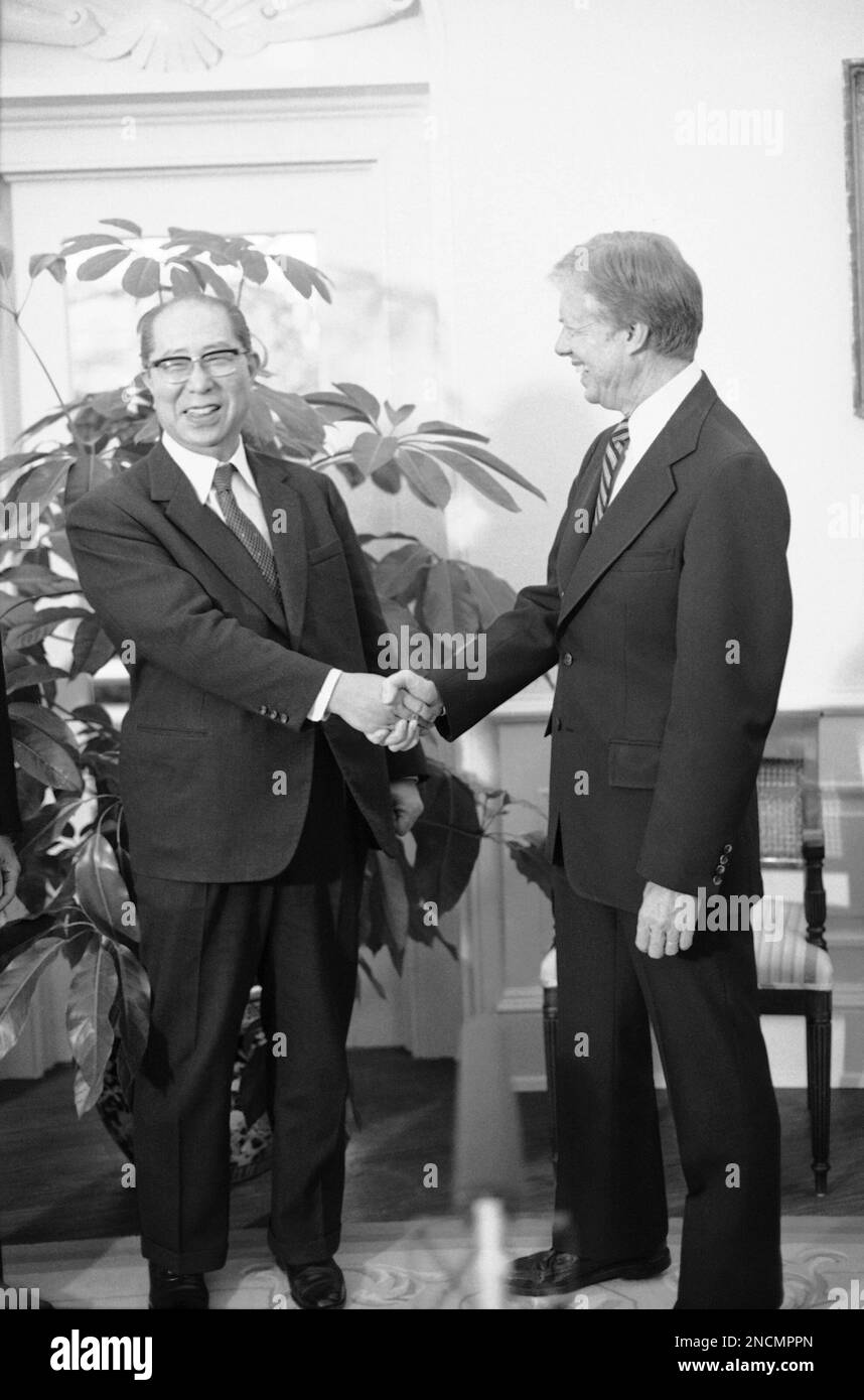 Japanese Foreign Minister Saburo Okita beams as he shakes hands with ...