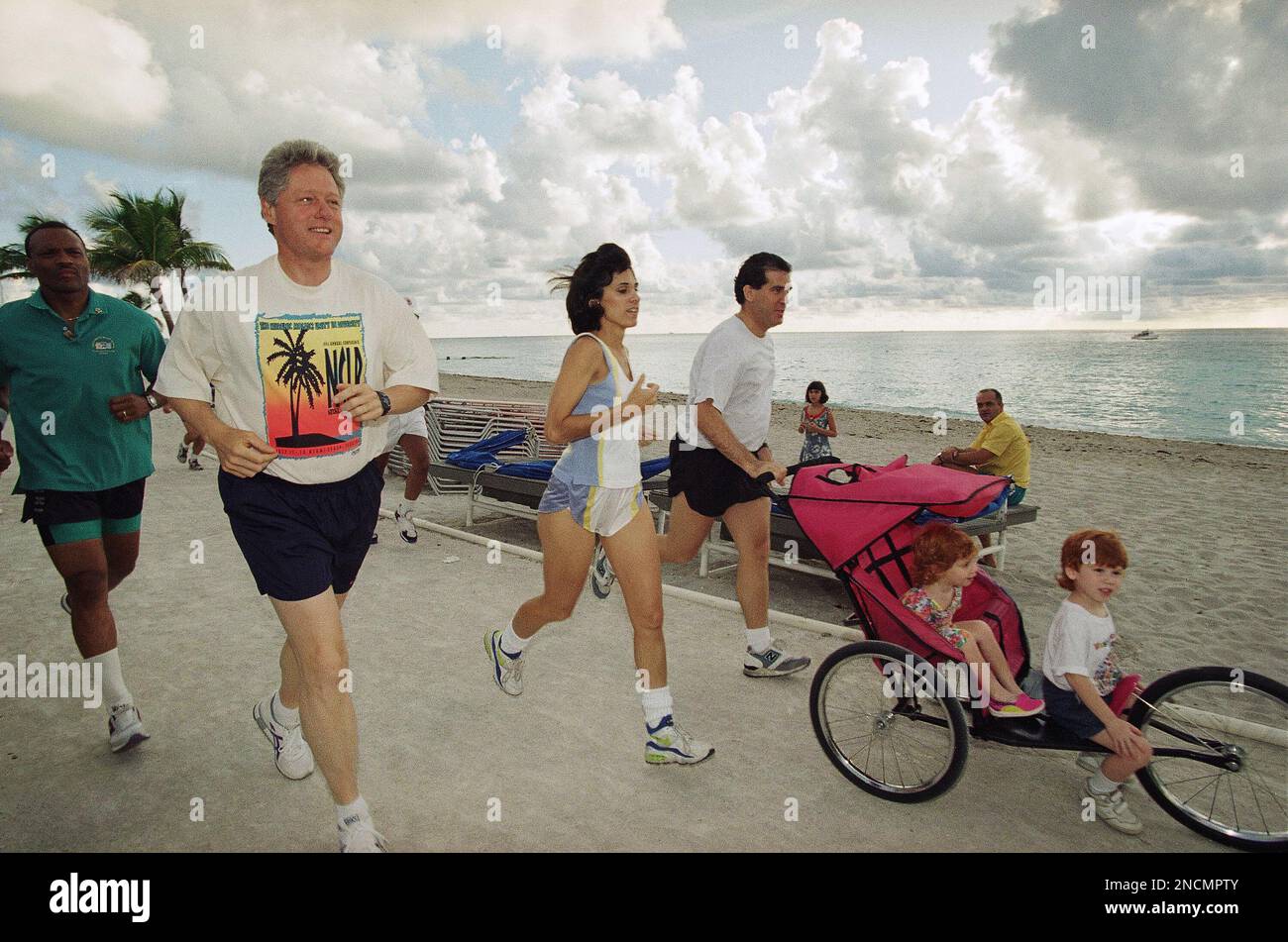 President Bill Clinton jogs with Rep. Peter Deutsch, D-Fla., his wife ...
