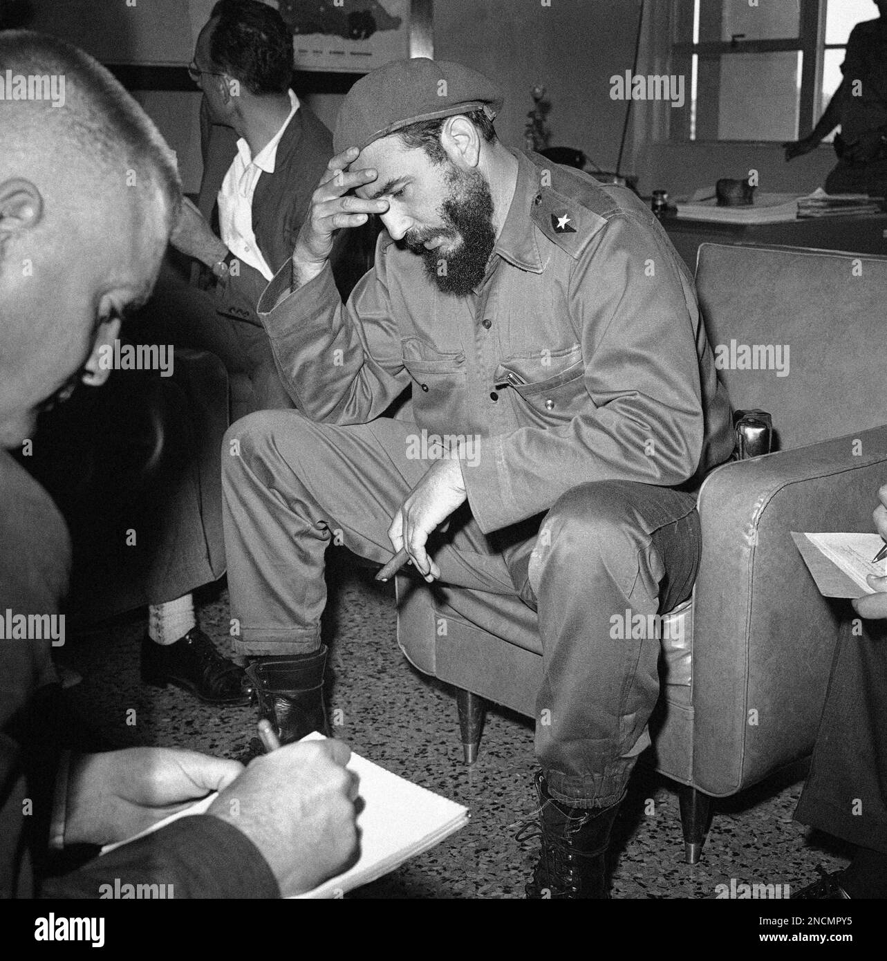 Cuban Prime Minister Fidel Castro holds his hand to his head as he ...