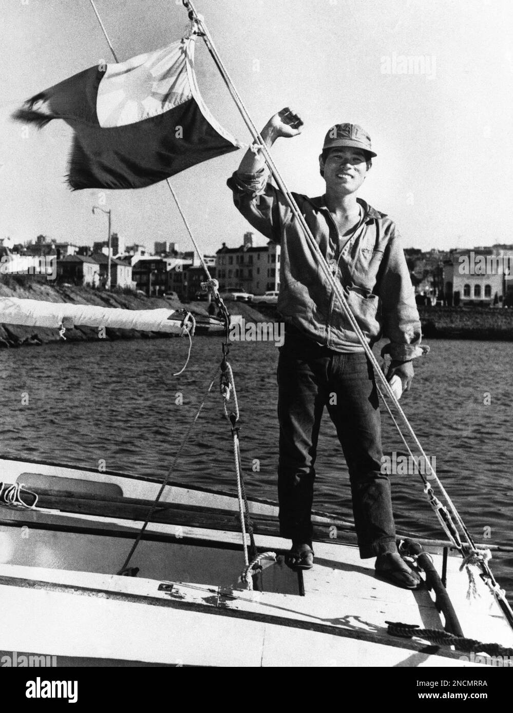 Japan's Kenichi Horie waves from his 19-foot boat which has carried him ...