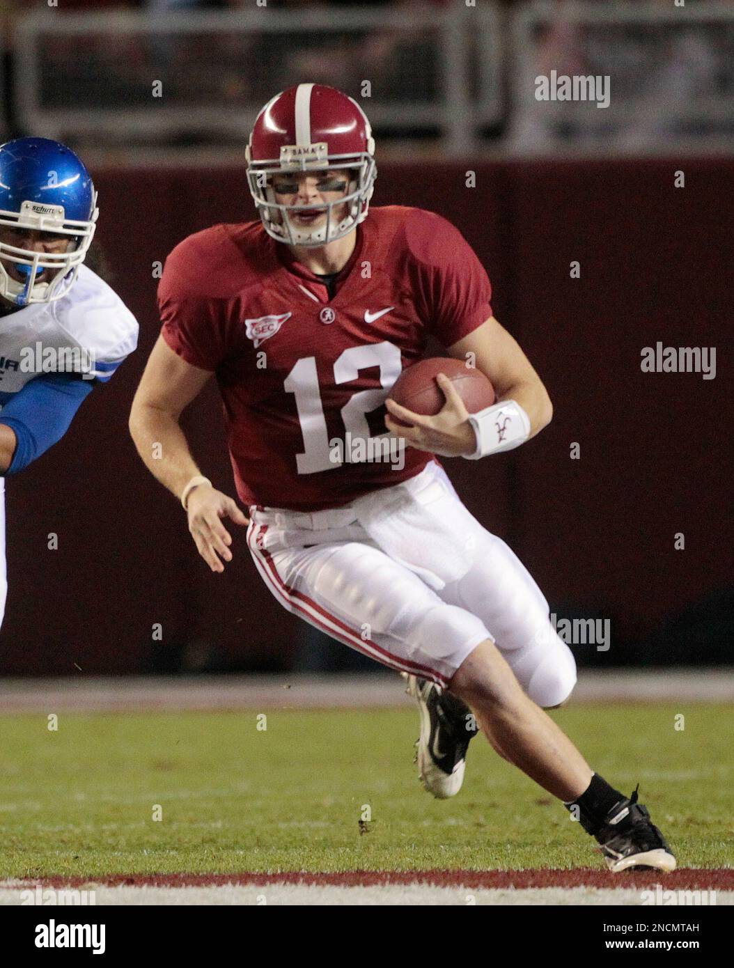 Alabama quarterback Greg McElroy looks for running room in the first ...