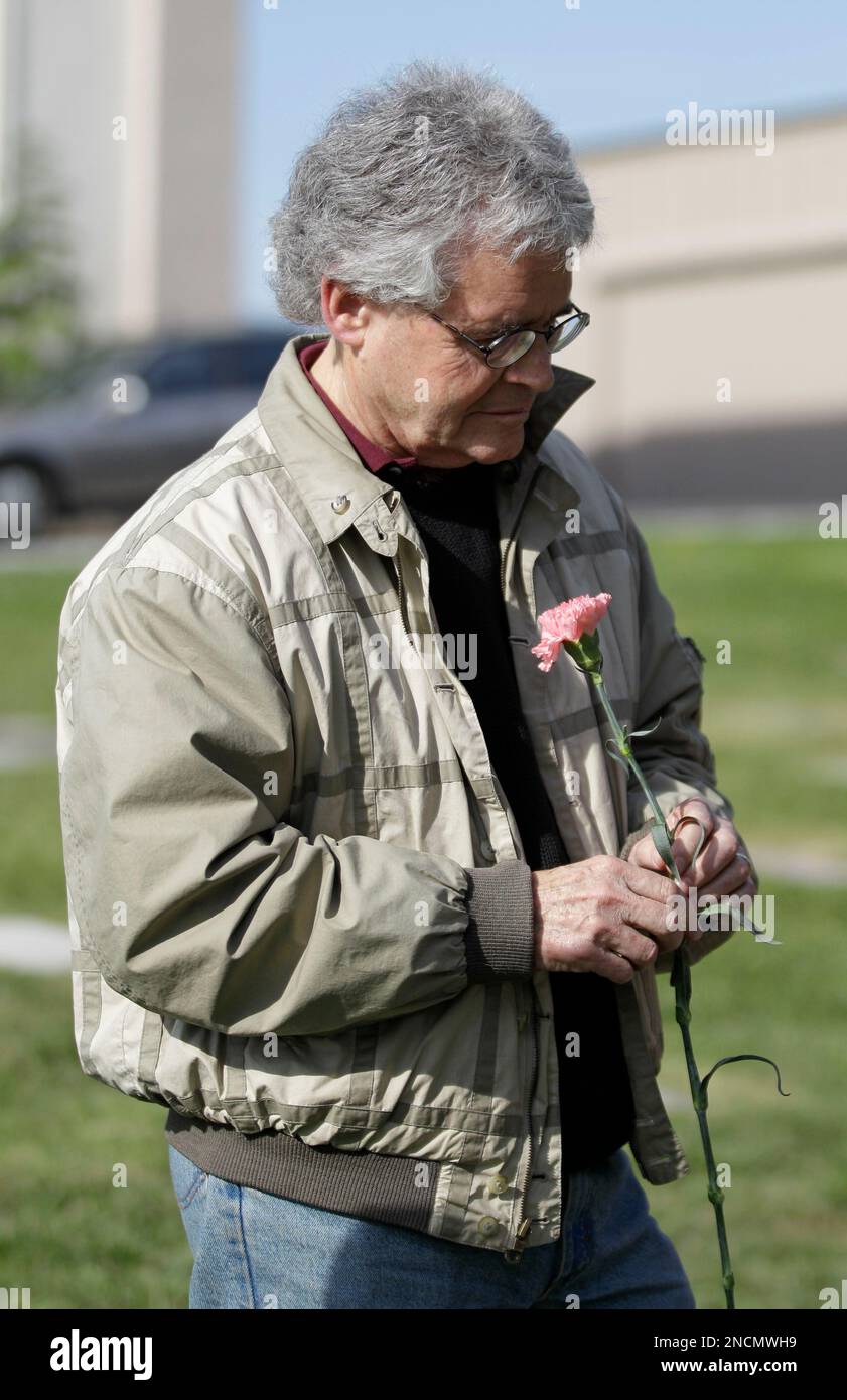 Former Peoples Temple member Tim Stoen holds a flower while listening ...
