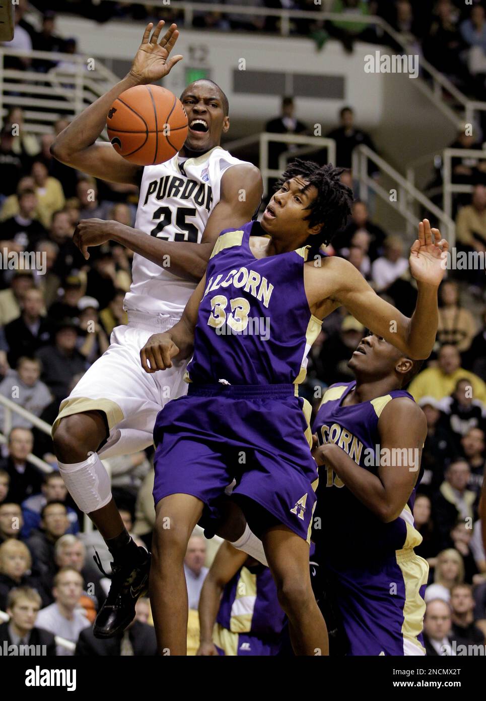 Purdue's JaJuan Johnson, left, gets a basket on a slam dunk over Alcorn ...