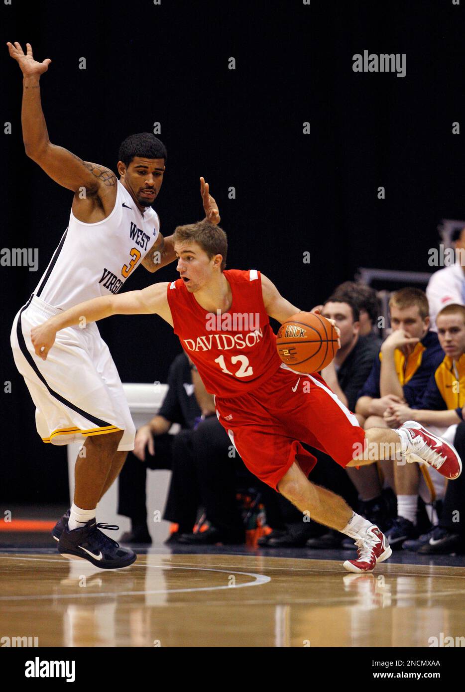Davidson’s Nik Cochran, right, drives the ball against West Virginia’s ...