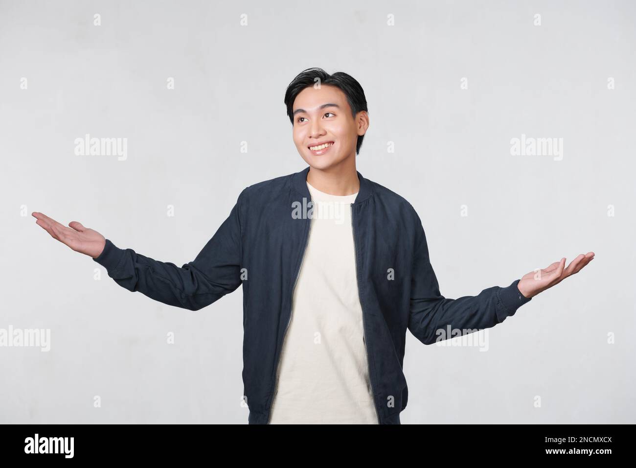 Cheerful casual man welcoming with his hands wide open on white ...