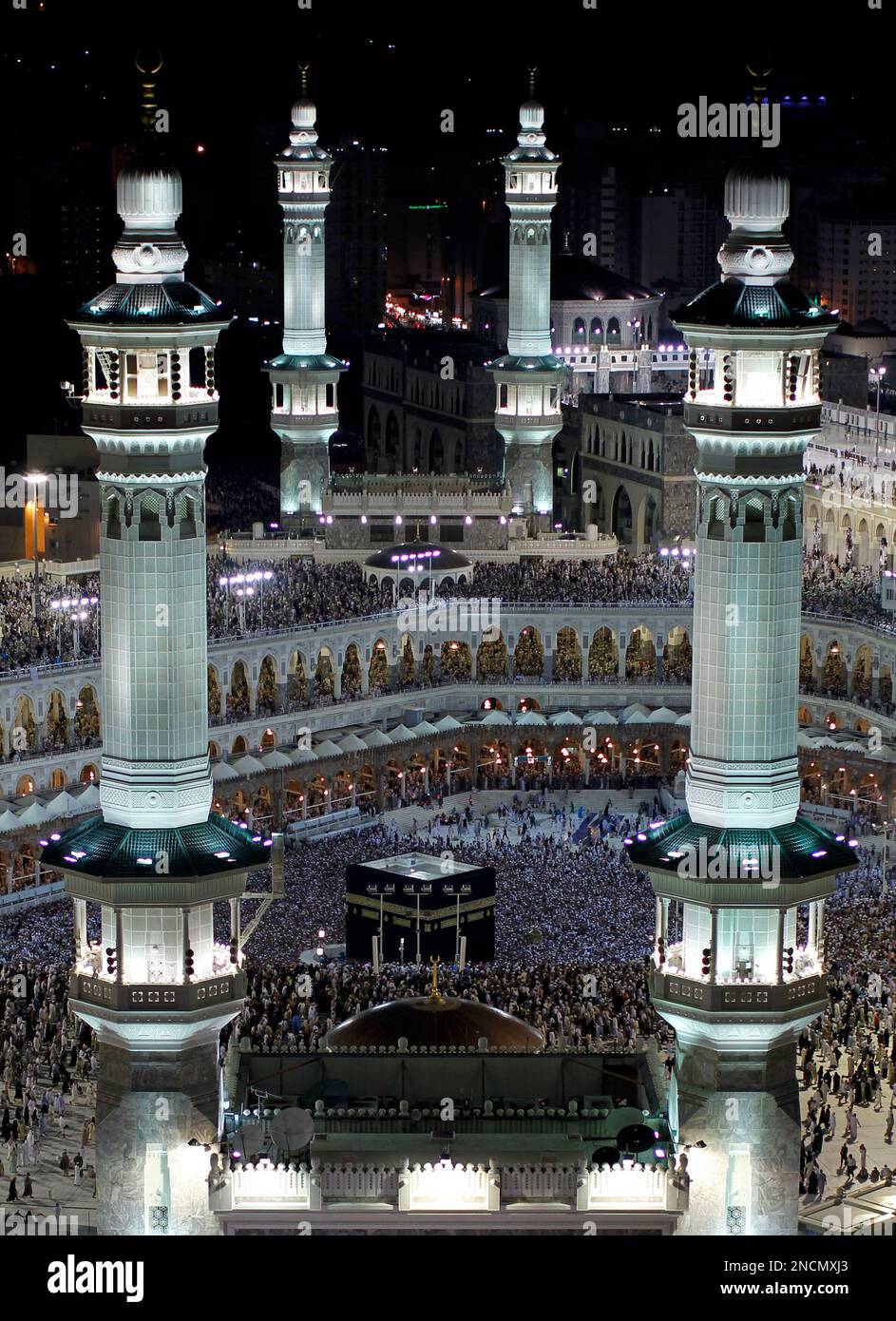 Tens of thousands of Muslim pilgrims moving around the Kaaba, the black ...