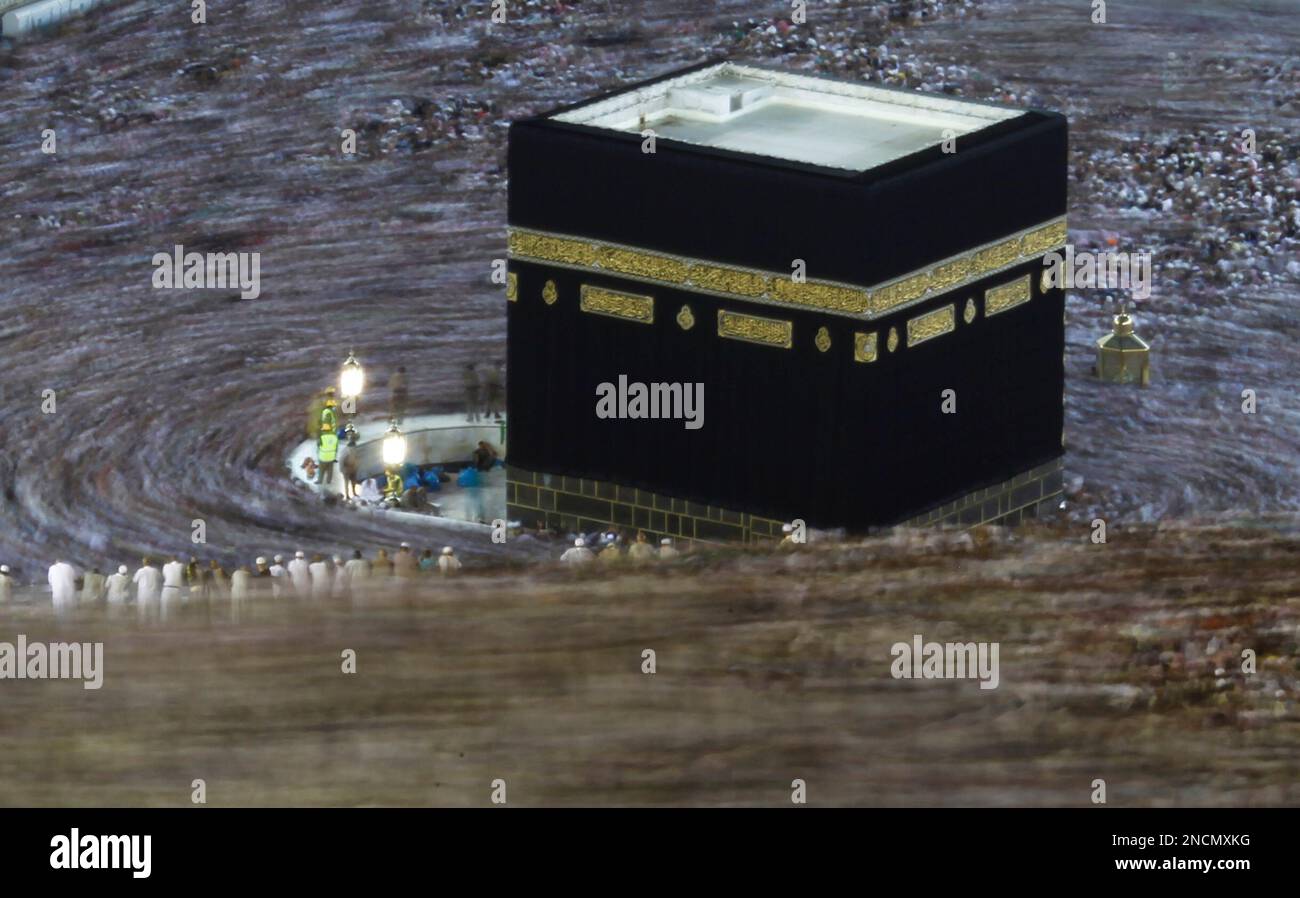 Tens of thousands of Muslim pilgrims moving around the Kaaba, the black ...