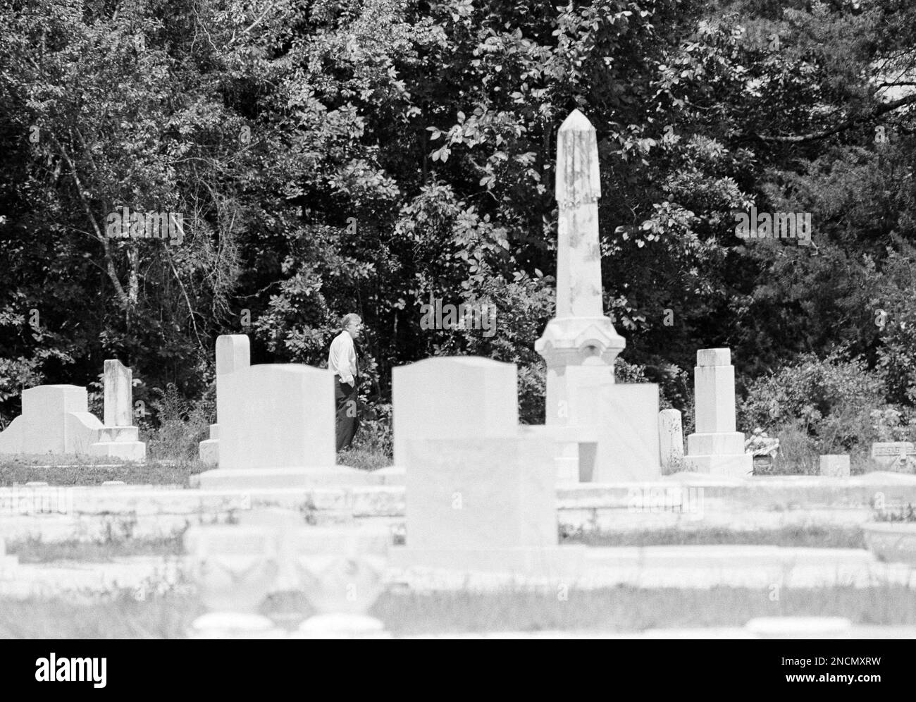 President Jimmy Carter, hands in pockets, walks from the grave of his ...