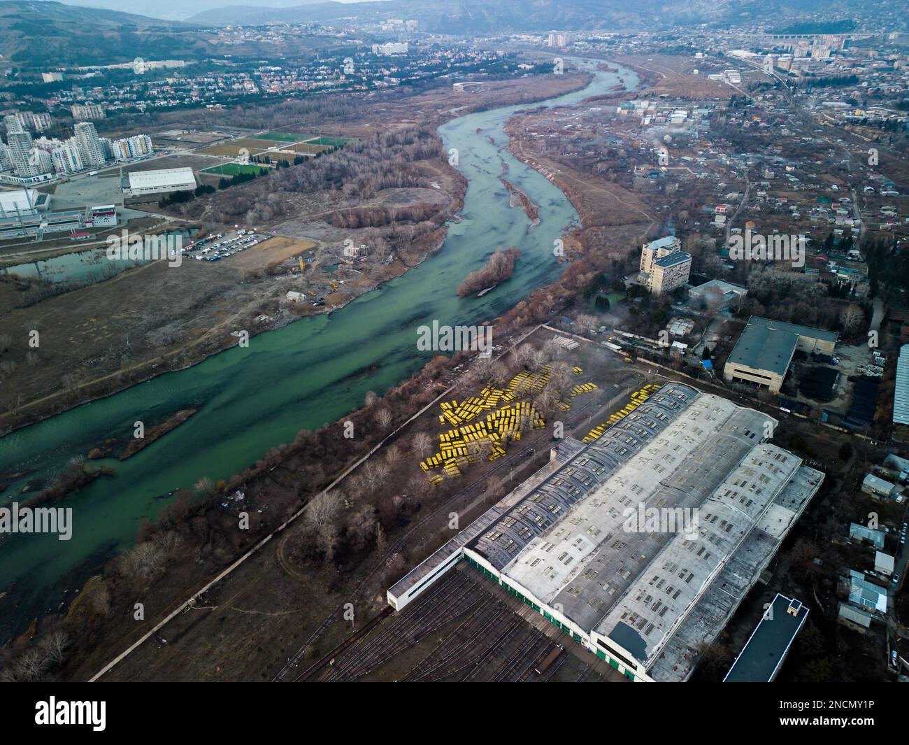 An aerial view of city buildings on both sides of a river in the ...