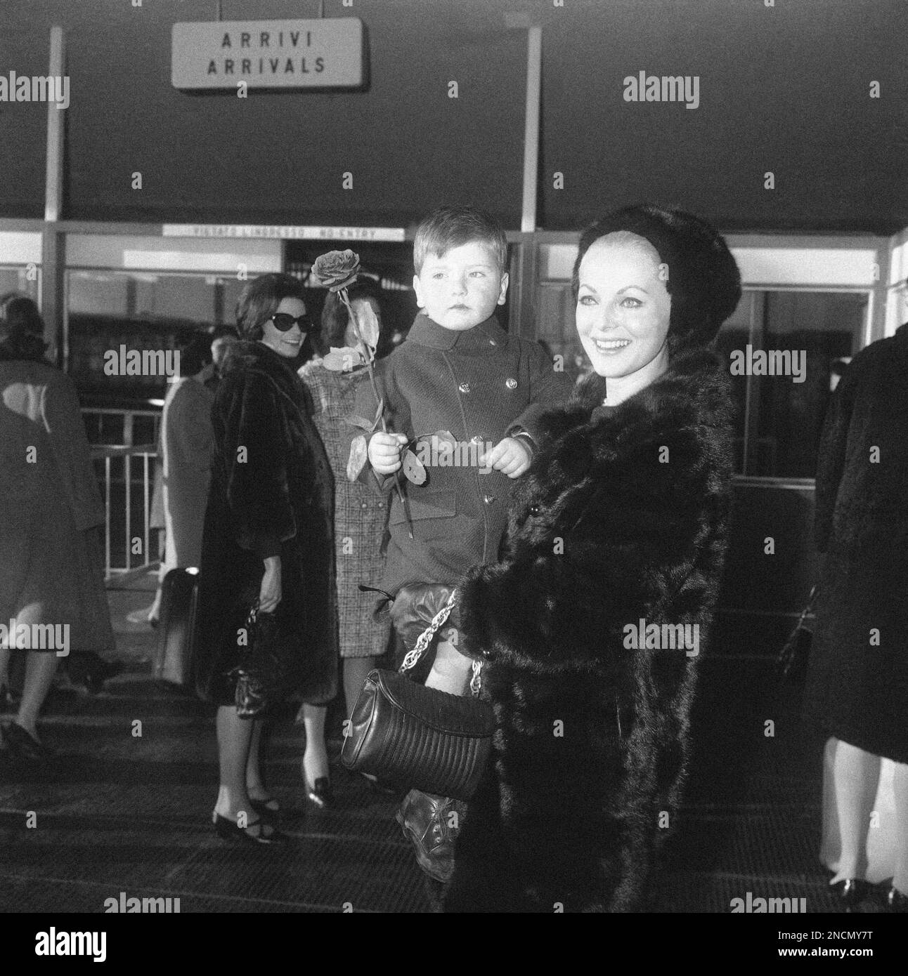 Her son, Corrado, welcomes Italian actress Virna Lisi with a big rose ...