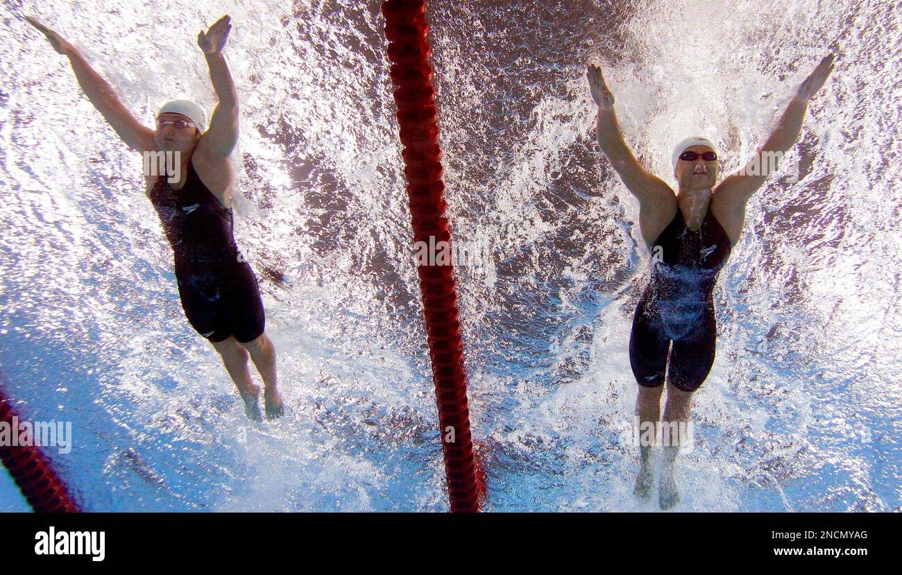 Singapore's Tao Li, left, competes alongside China's Lu Ying on her way ...