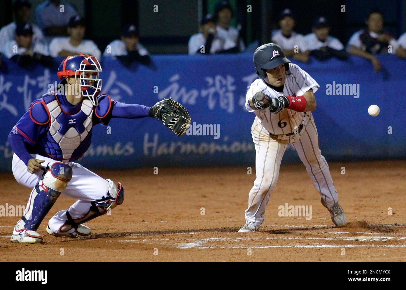 Japan's Yuichi Tabata, right, bunts during their baseball semifinal ...