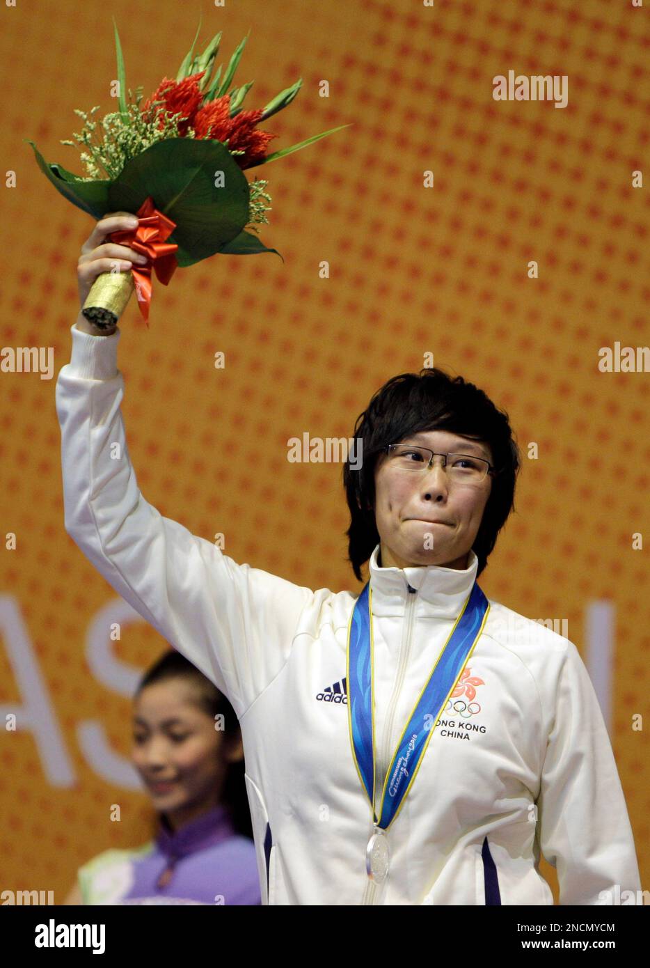 Hong Kong's Au Sin Ying celebrates on the podium after taking the ...