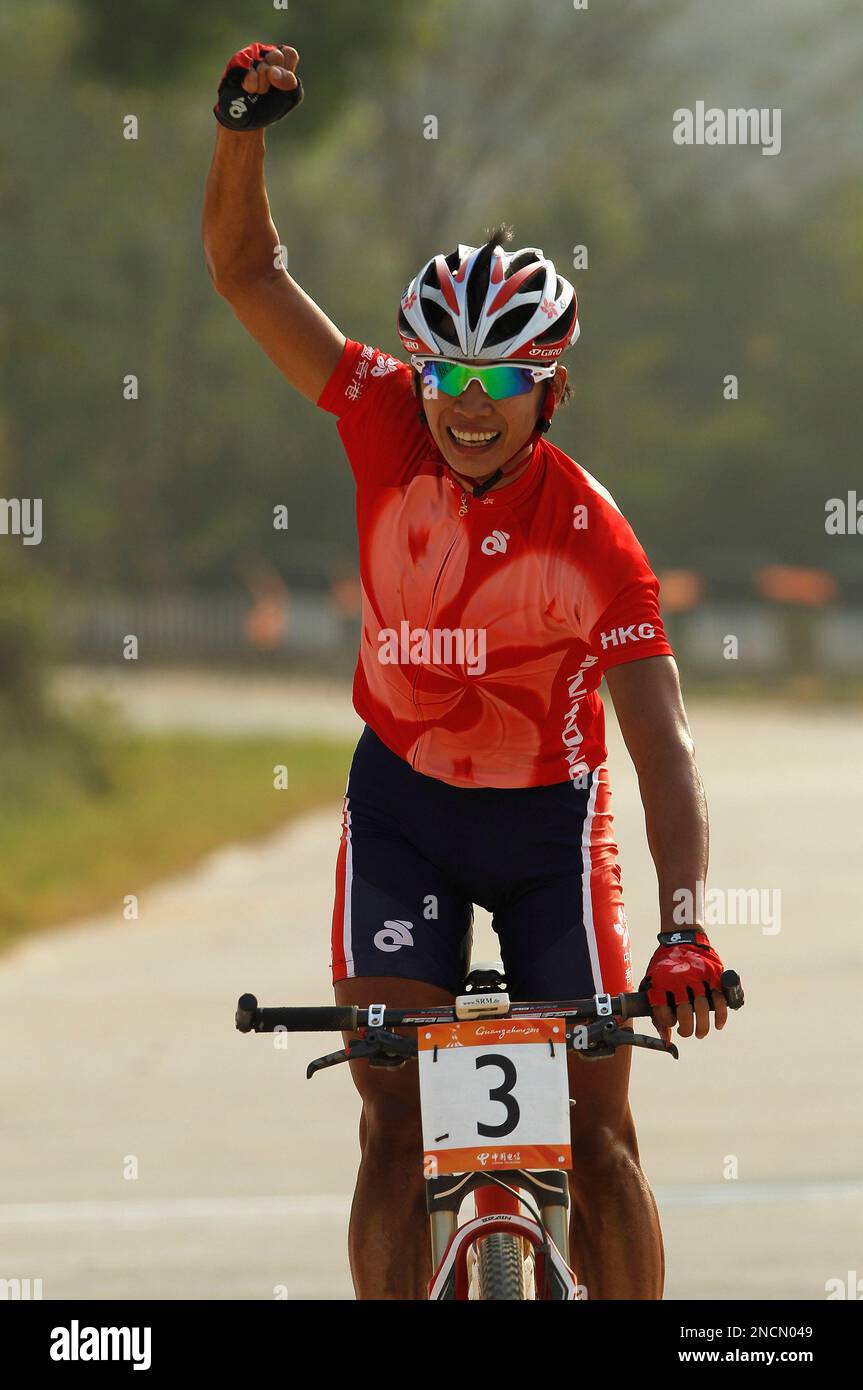 Hong Kong's Chan Chun Hing celebrates as he crosses the finish line to ...