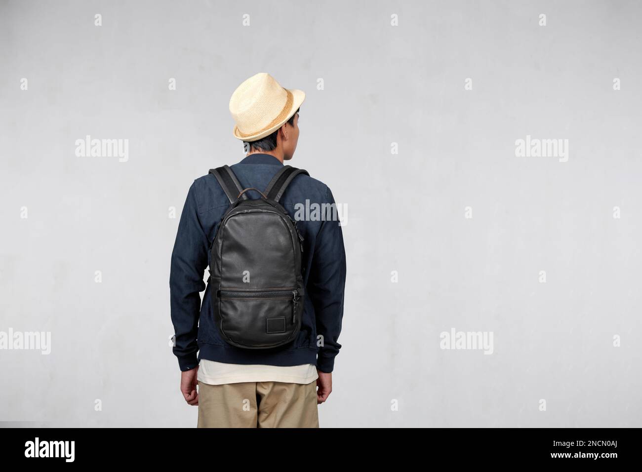 back view of young man tourist in straw hat with backpack isolated on ...