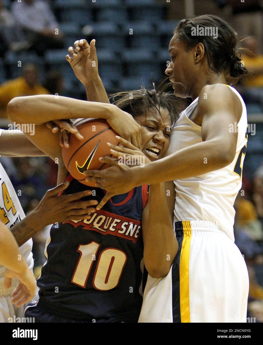 West Virginia's Asya Bussie, right, guards Duquesne's Wumi Agunbiade ...