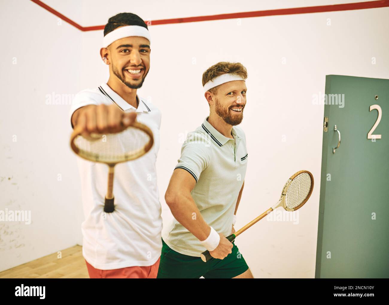 We challenge you to a game of squash. two young men playing a game of ...