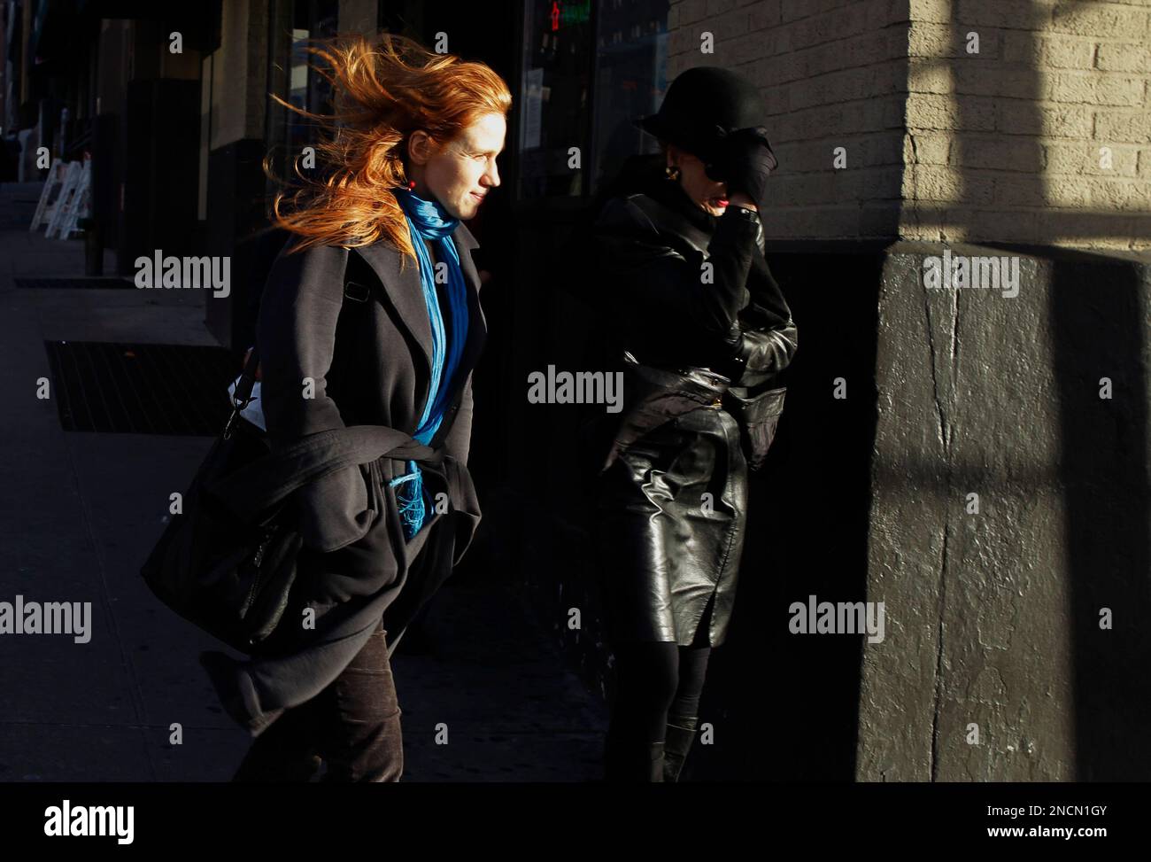 Women walk around a corner into high winds in New York, Wednesday, Nov ...