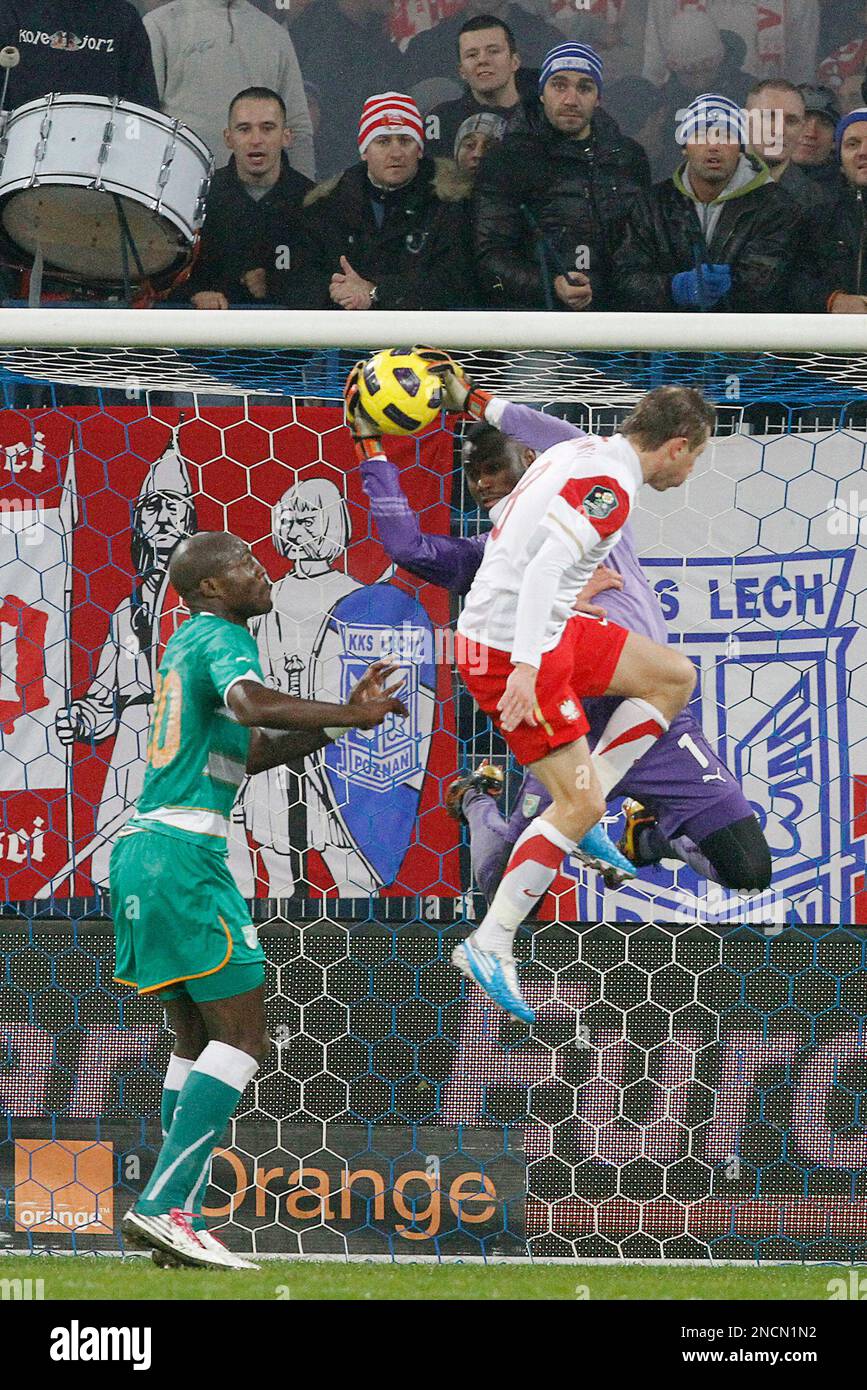 Poland's Rafal Murawski ,right, is challenged by Guy Demel , left, and ...