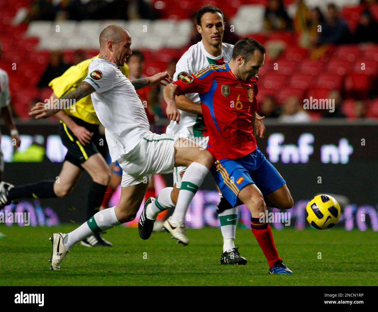 Spain's Andres Iniesta, right, fights for the ball with Portugal's Raul ...