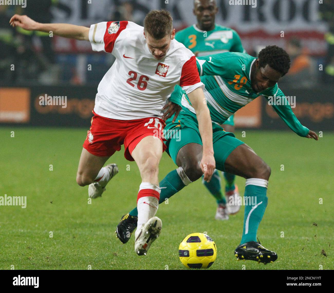 Poland's Lukasz Piszczeki , left, is challenged by Kader Keita of Ivory ...