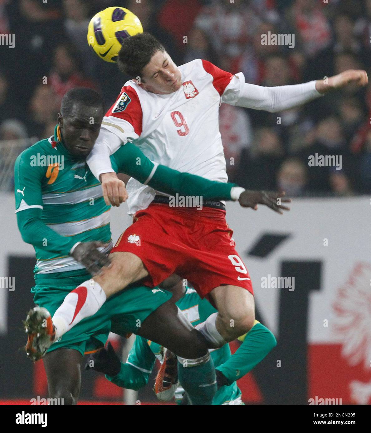 Poland's Robert Lewandowski , right, is challenged by Cheick Tiote of ...