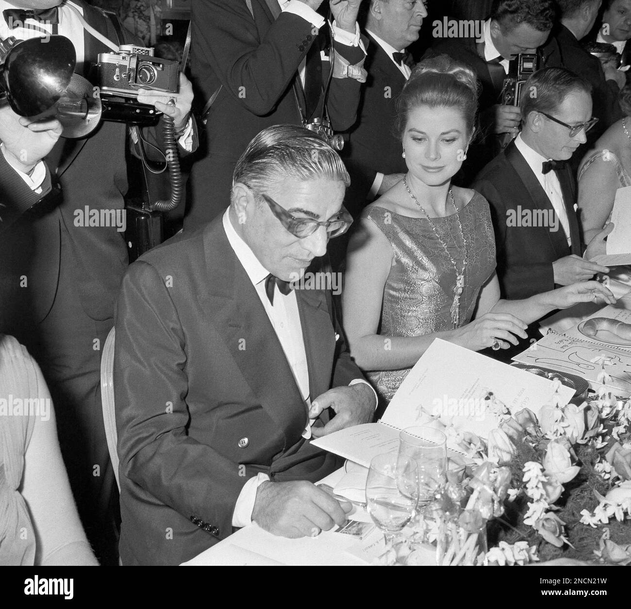 Princess Grace of Monaco looks over shoulder of Greek shipping magnate ...