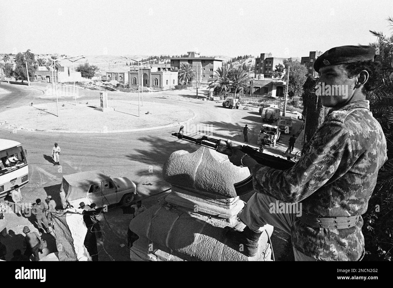 An Iraqi soldier is on guard with his Kalashnikov sub-machine gun ...