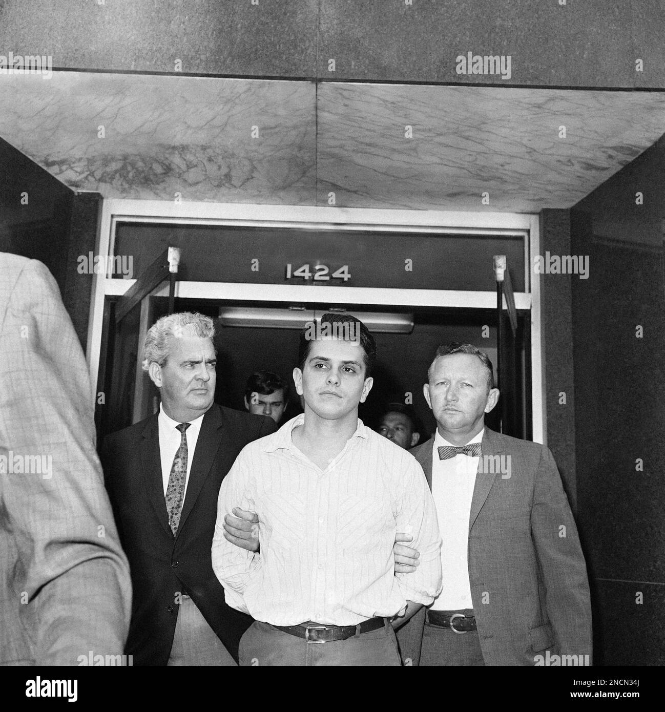 Detectives lead John Patler from Arlington, Va., police headquarters on ...