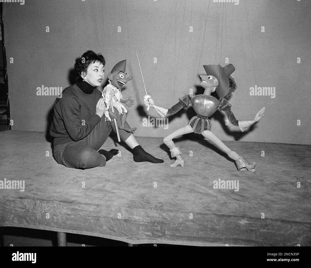 Two of the Baird marionettes work with dancer Sono Osato on a scene for ...