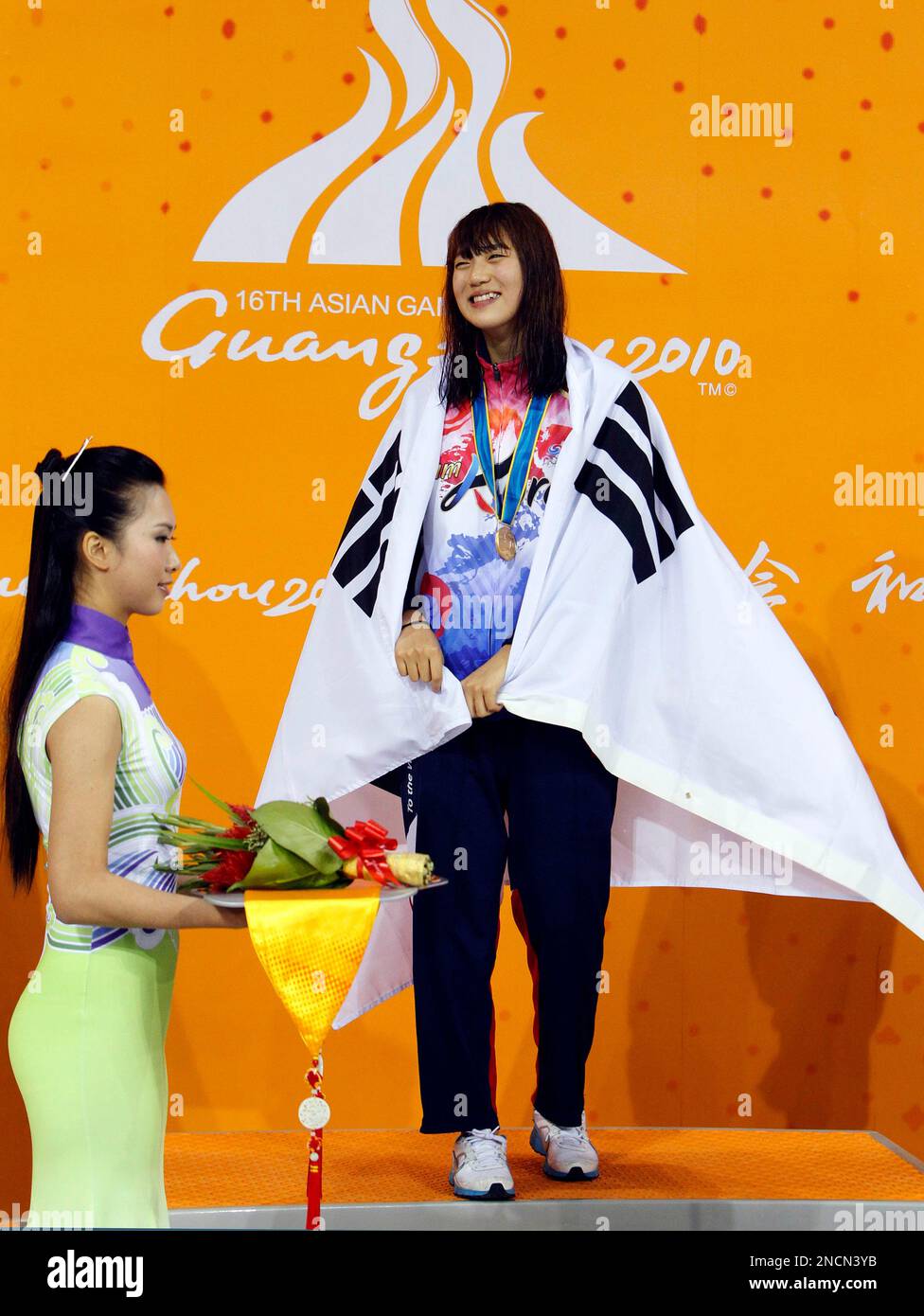 South Korea's Jeong Darae is wrapped in a national flag as she ...