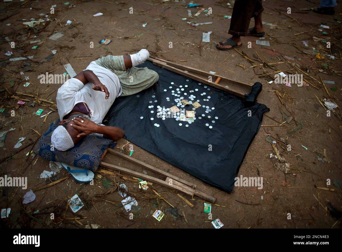 An Indian Muslim beggar waits for alms outside the Jama Masjid mosque ...