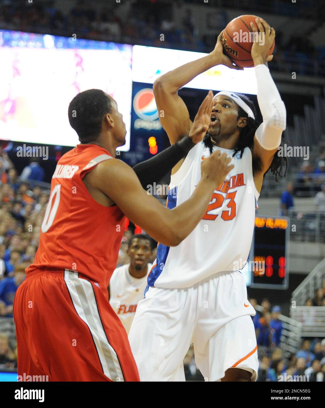 Florida's Alex Tyus (23) tries to get a shot off as Ohio State forward ...