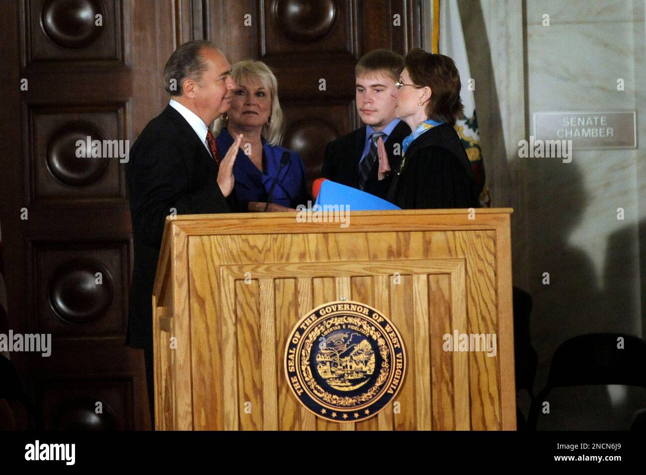 West Virginia Gov. Earl Ray Tomblin, left, is sworn into office by ...