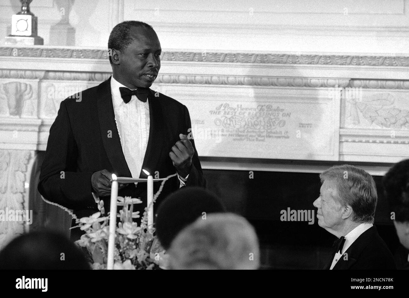 Kenya’s President Daniel Arap Moi stands to propose a toast as ...