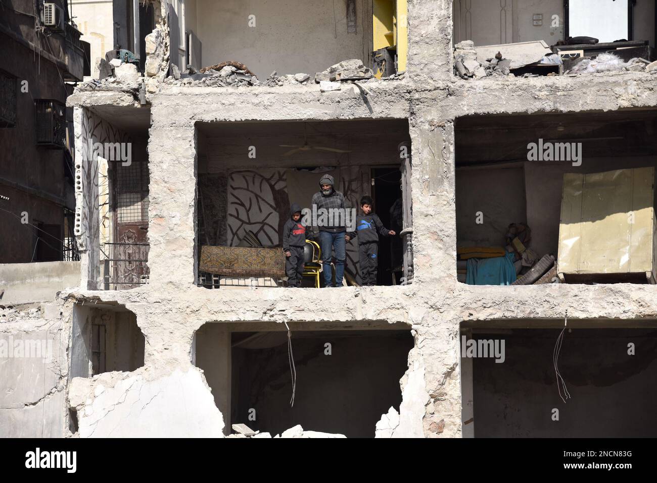 Saleppo, Syria. 13th Feb, 2023. Ali Abdul-Rahman and his two kids stand ...