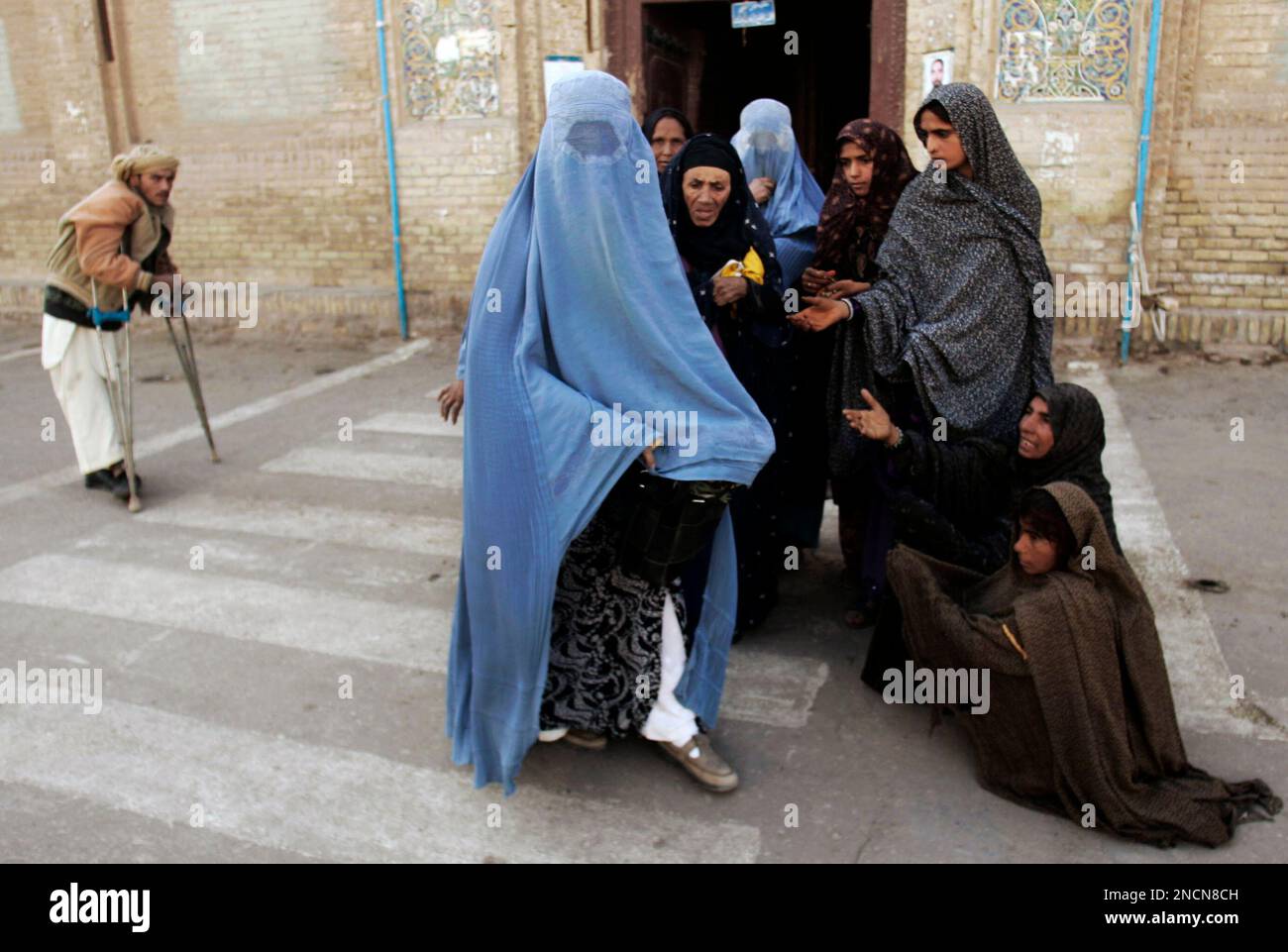 Afghan women beg outside a mosques during Eid Al-Adha religious holiday ...