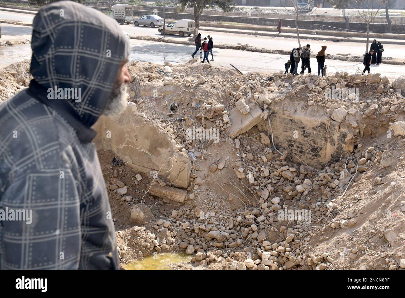 Saleppo, Syria. 13th Feb, 2023. Ali Abdul-Rahman stands on the side of ...