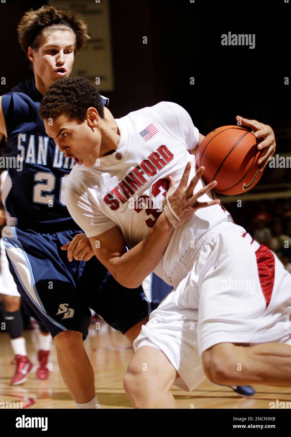 Stanford forward Dwight Powell, right, dribbles past San Diego guard ...