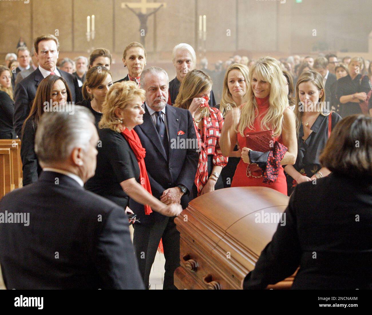 Martha De Laurnetiis stands behind her husband's casket as her daughter ...