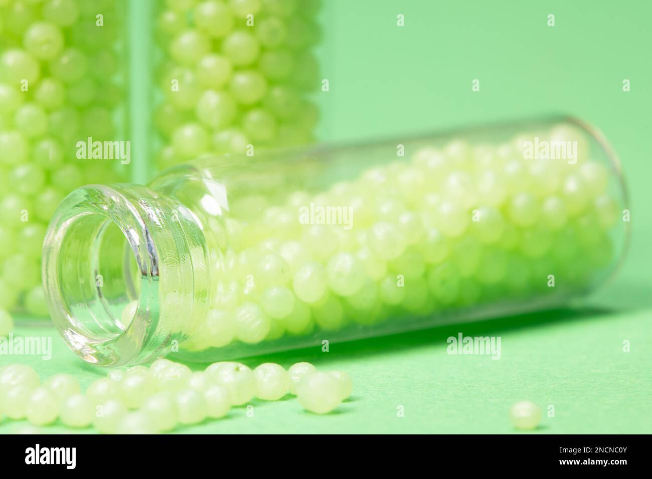 bottles with green granules on a green background Stock Photo - Alamy