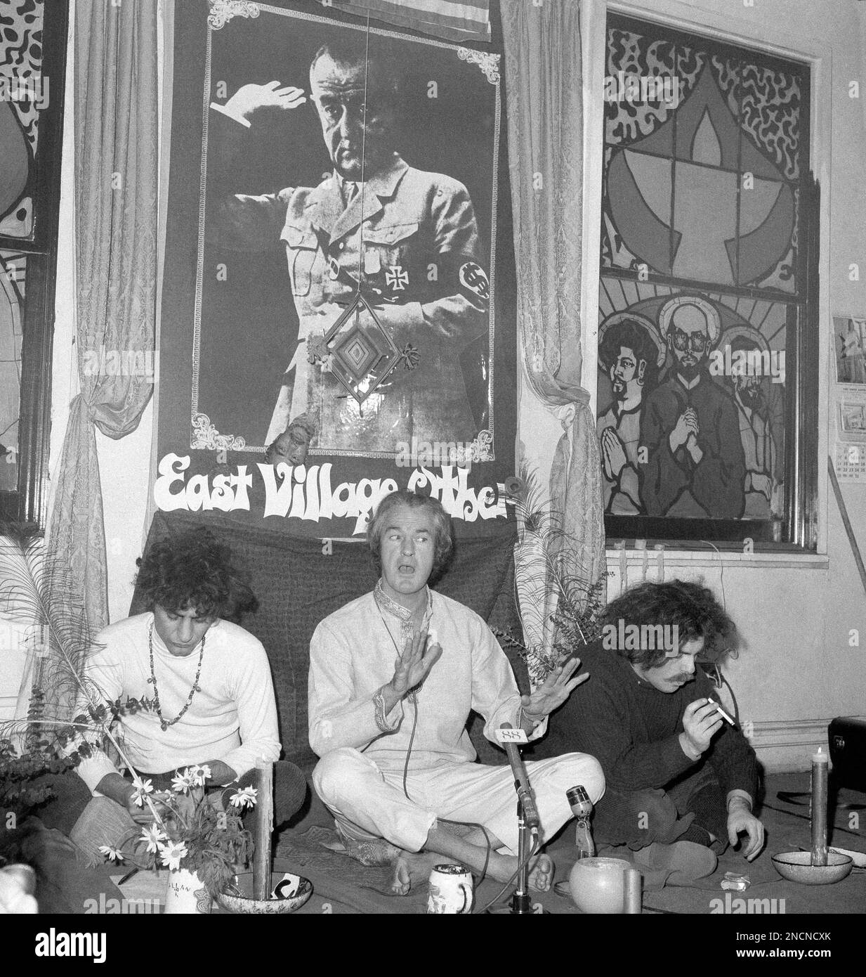 Seated before a picture made to show President Johnson in a Hitler-life ...