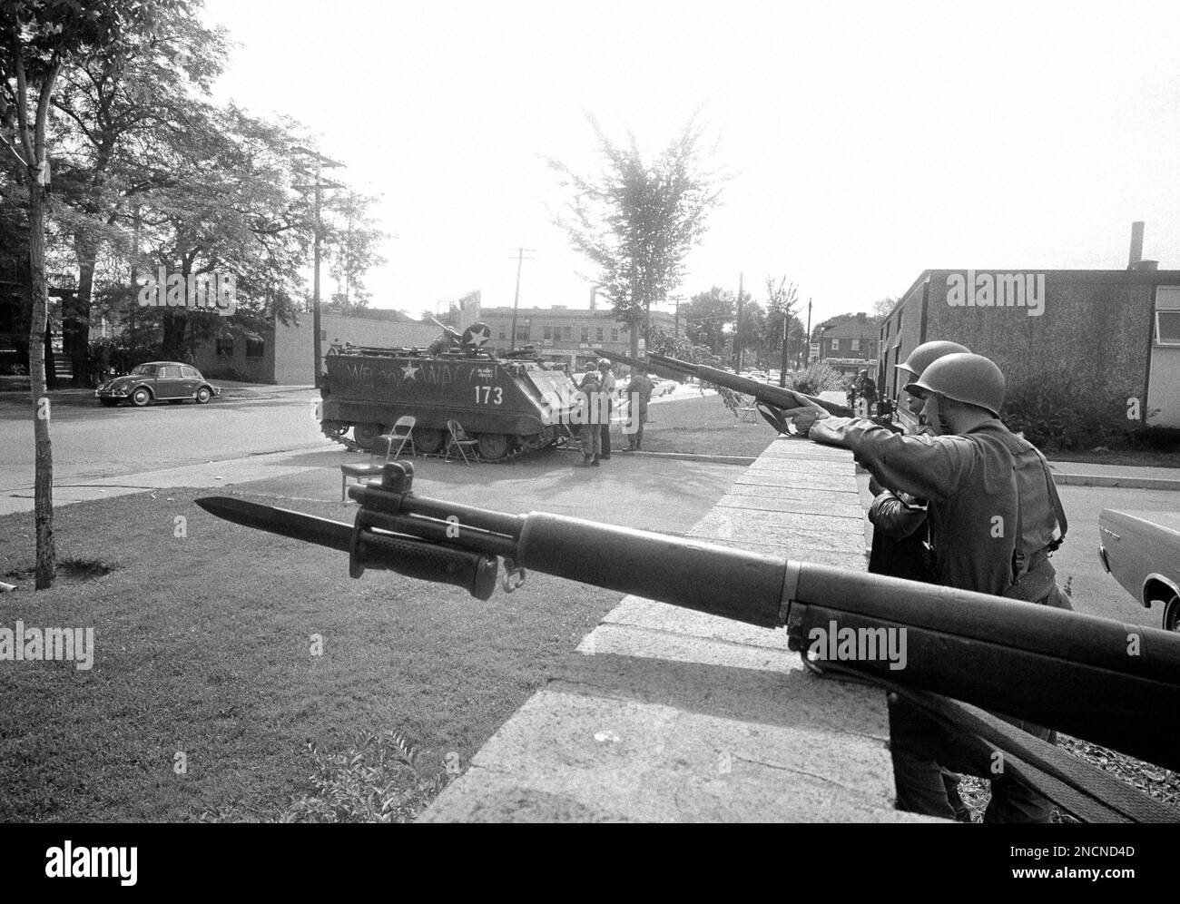 Army personnel with fixed bayonets and a carrier with a machine gun at ...