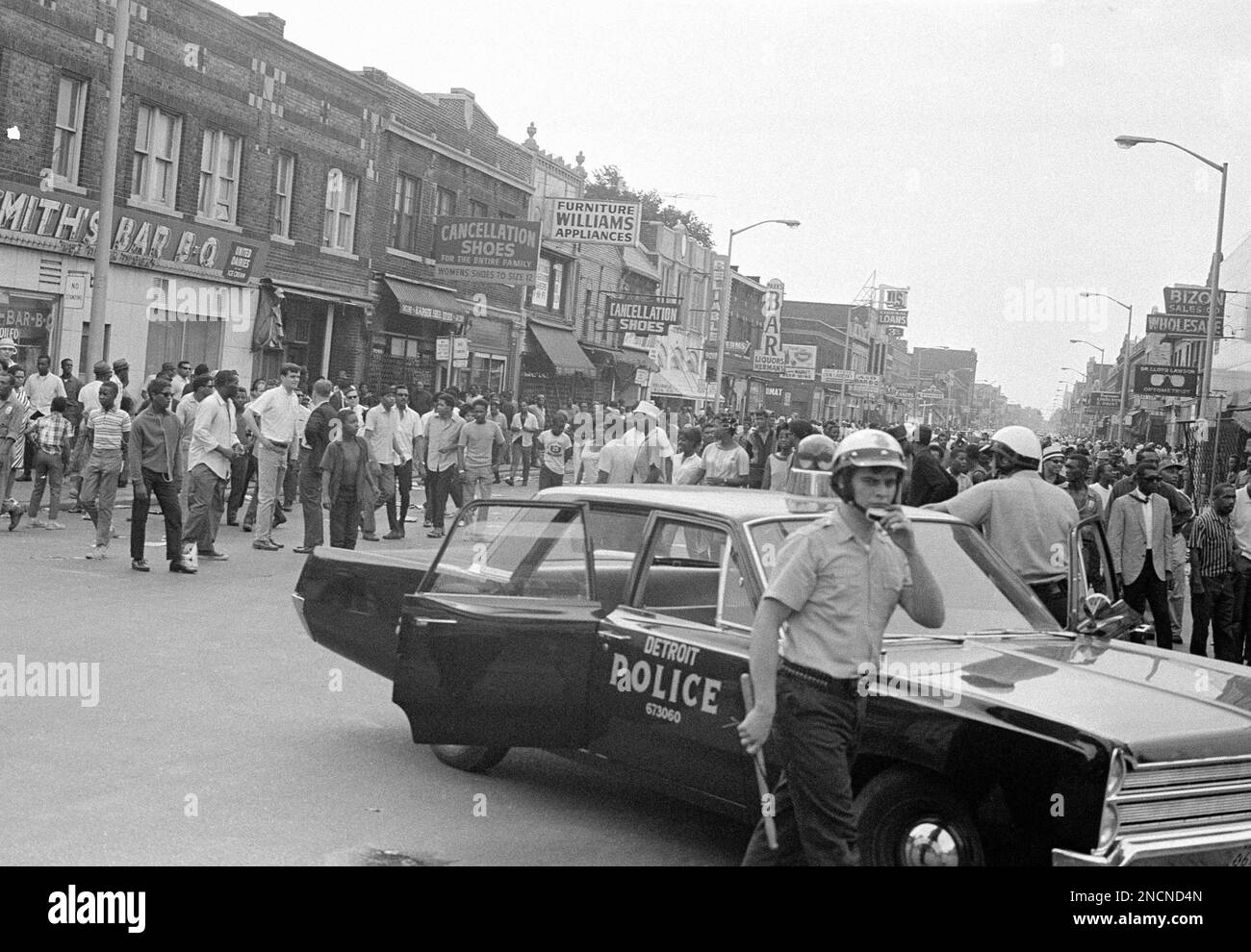 A police car blocks off an area of 12th Street in Detroit where racial ...