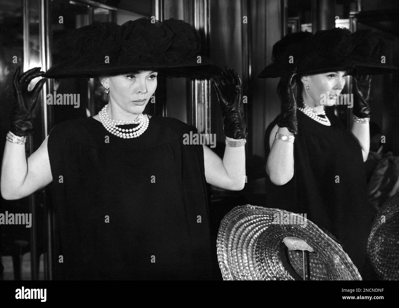 Actress Zsa Zsa Gabor wearing a hat by designer Jean Patou, unseen, in ...