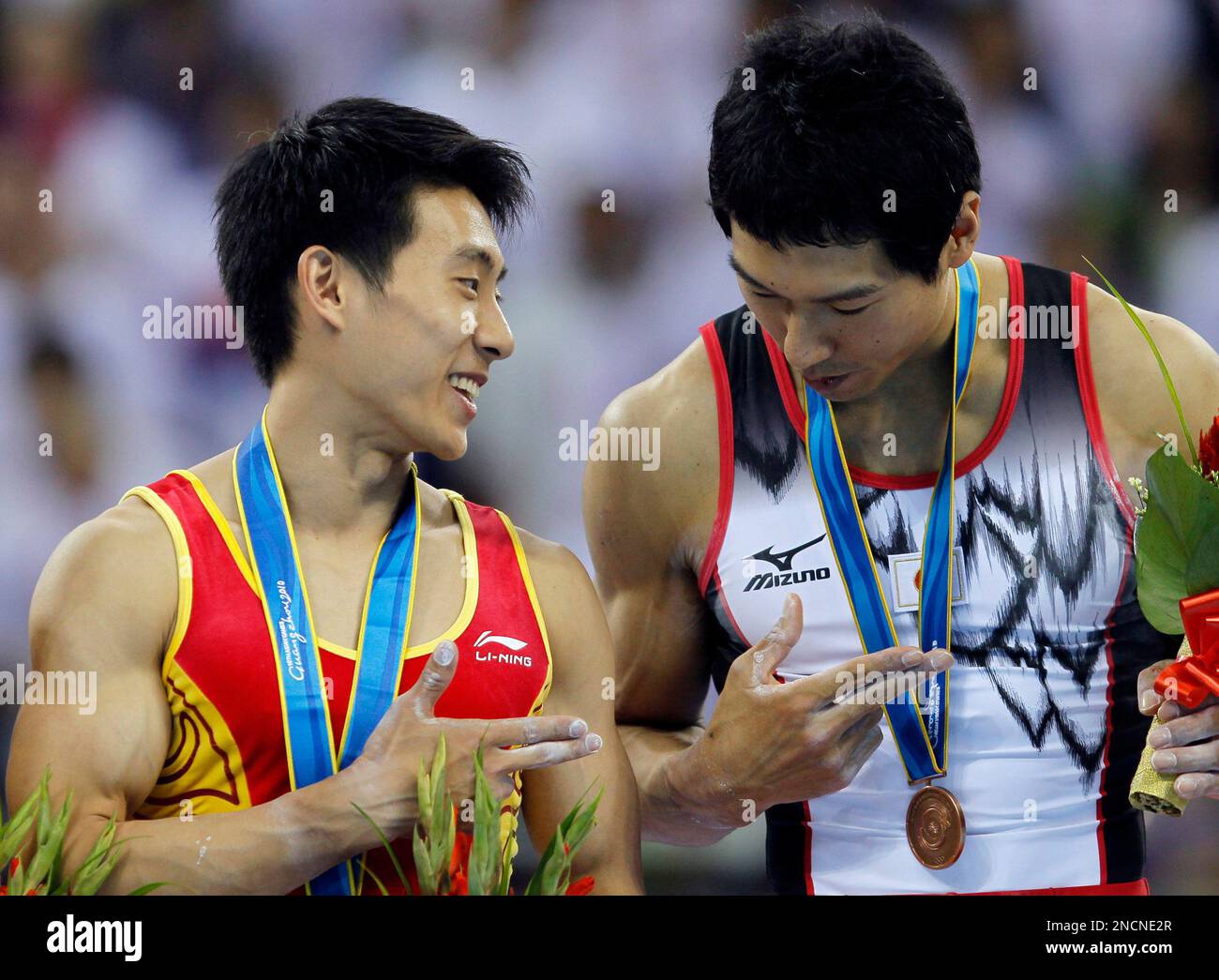 Gold medalist China's Teng Haibin, left, explains to bronze medalist ...
