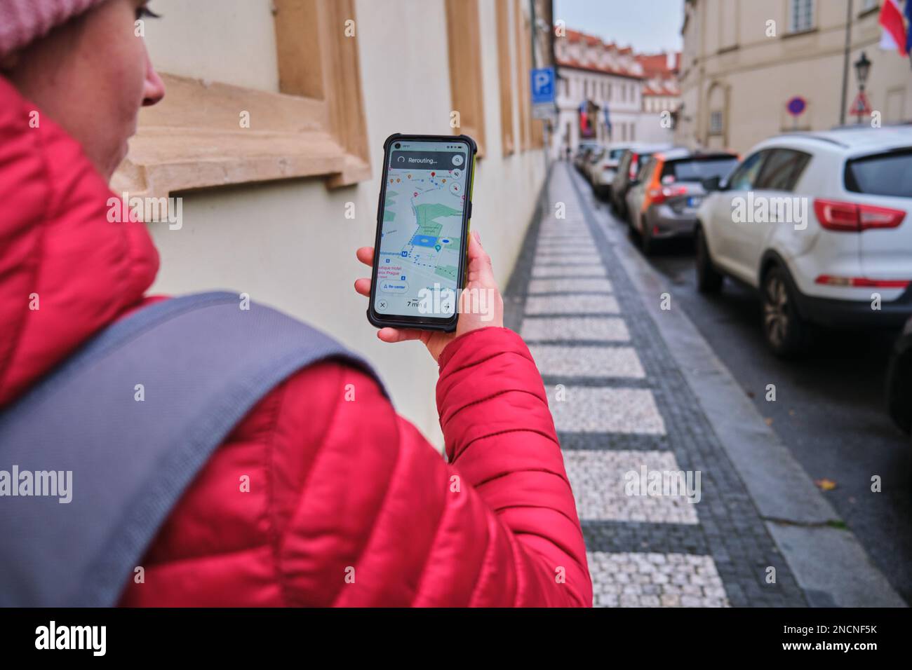 Woman, hand looks at map on phone and plots a route for a trip GPS ...